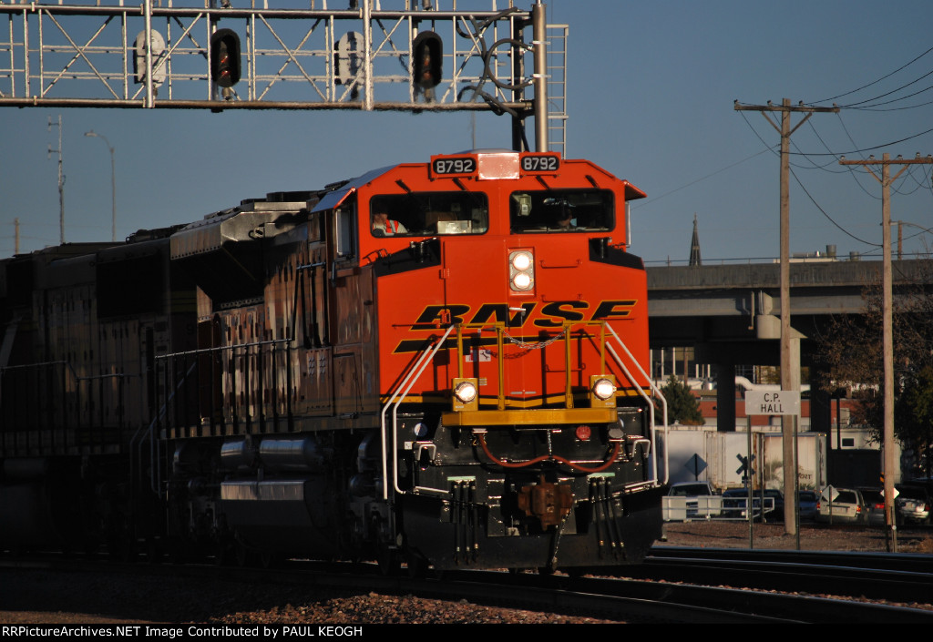 BNSF 8792 Reflects the late afternoon Sun as she heads into the BNSF Lincoln yard pulling a ...